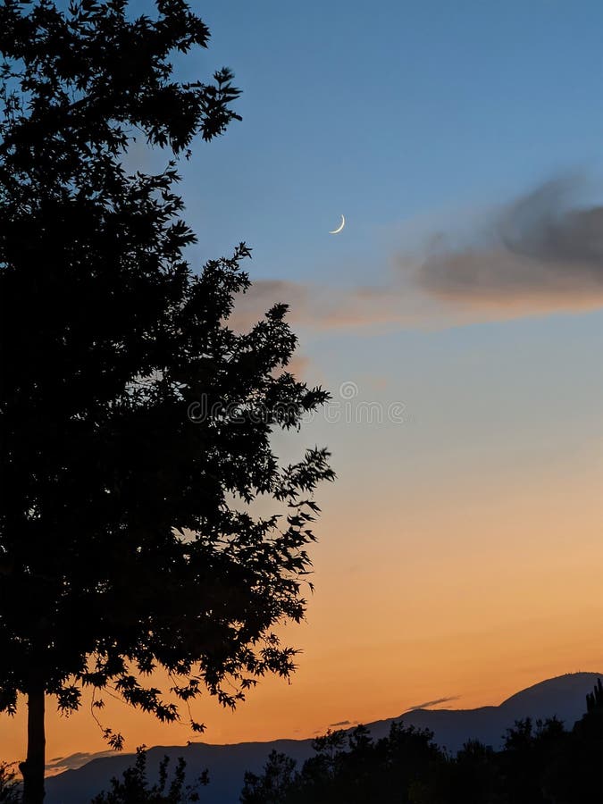 Dramatic Sunset Colors and Thin Crescent Moon at the Evening Sky Stock ...