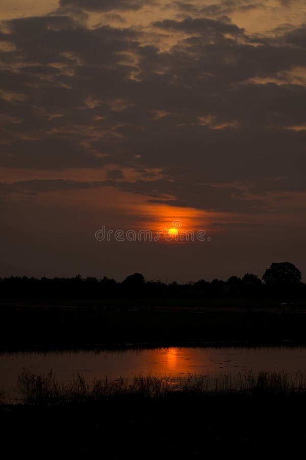Dramatic Sunset Landscape with Dark Sky, Silhouettes of Trees and Lake ...
