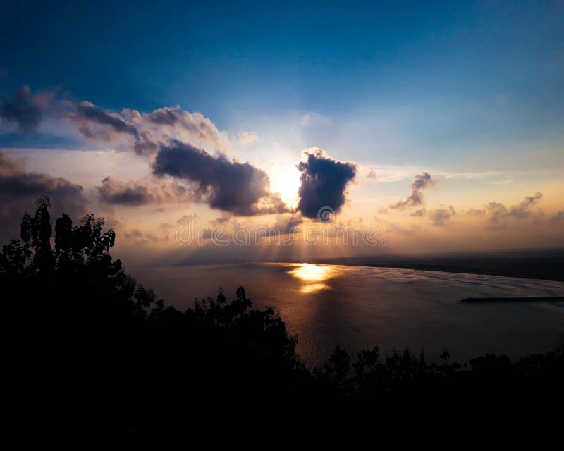 Dramatic Sunset at the Ocean with Cloudy Sky Wings Stock Image - Image ...