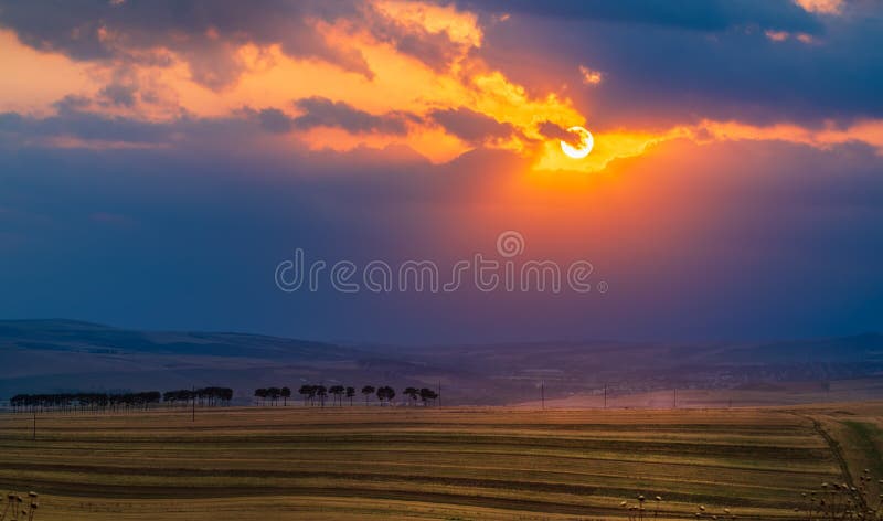 Dramatic Sunset Over Farm Fields Stock Photo - Image of grass, dark ...