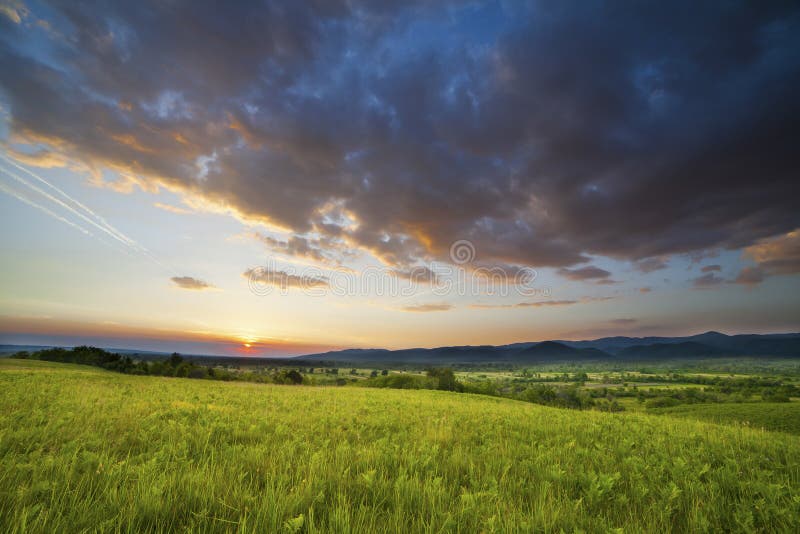Dramatic Sunset Over Green Field Stock Photo - Image of country ...