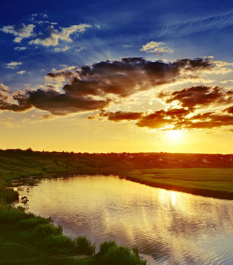 Dramatic sunset over river stock image. Image of pond - 25214937