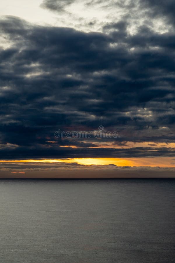 Dramatic Sunset Over the Sea Surface Stock Photo - Image of clouds ...
