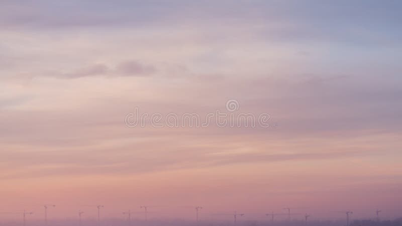 Dramatic Sunset Sky with Clouds and Construction Cranes Far Away Stock ...