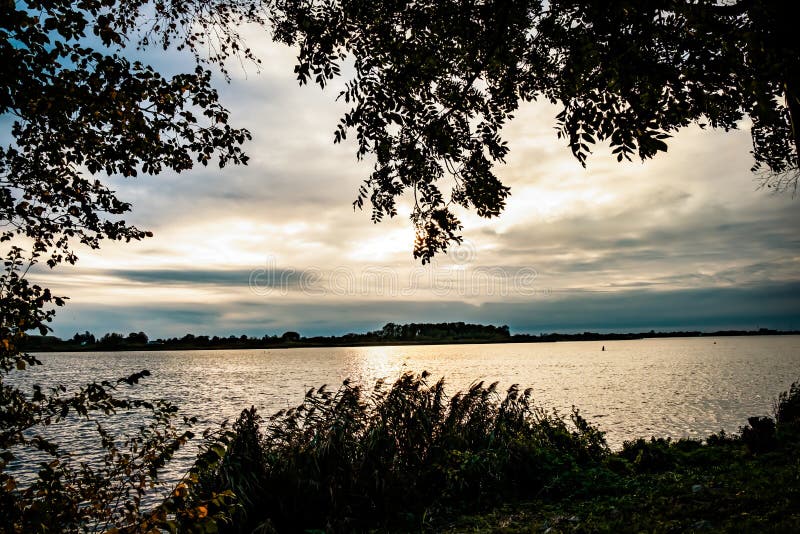 Dramatic Sunset Sky Over a Lake Stock Photo - Image of horizon, sunset ...