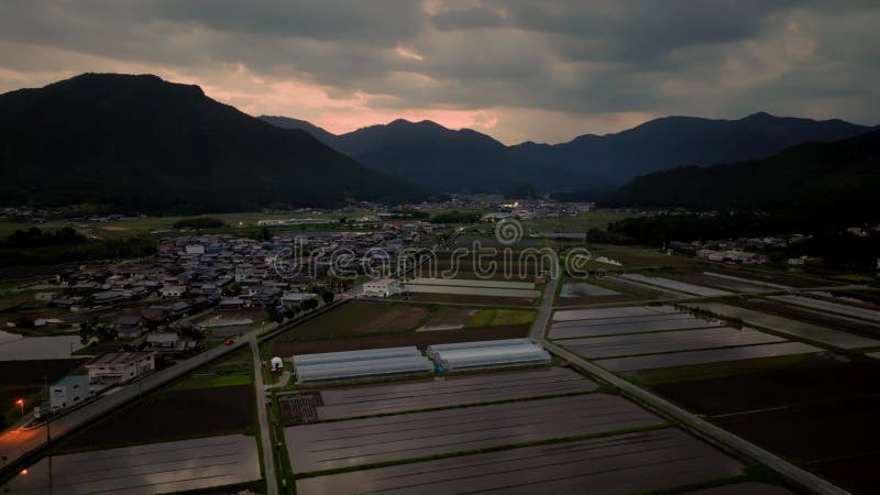 Dramatic Sunset Sky Reflects in Flooded Rice Fields Rising Above Rural ...
