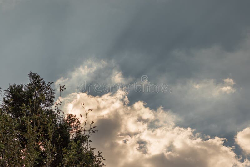 Dramatic Sunset with Streaks of Sun and Clouds Stock Image - Image of ...