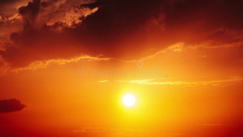 Dramatic Sunset with Sun Rays in the Sky through Orange Layered Clouds ...