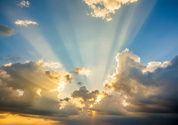 Dramatic Sunset with Sunbeams Breaking through Fluffy Clouds in a Vibrant Sky Stock Image ...