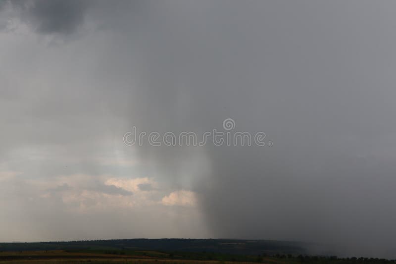 A Dramatic Thunderstorm with Dark Clouds and Heavy Rainfall Creates a ...