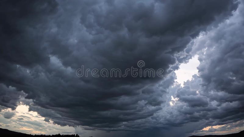 Dramatic Thunderstorm Sky with Dark Clouds and Distant Sunset Stock ...