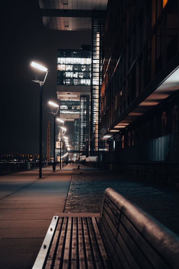 Dramatic Vertical Shot of a Bench at the Street at Night Stock Image ...