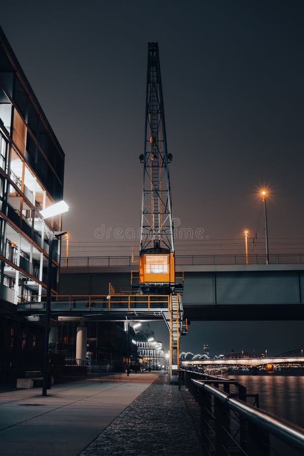 Dramatic Vertical Shot of a Construction Crane at the Bridge at Night ...