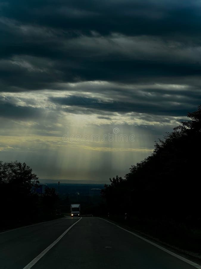 Dramatic Vertical View of a Highway Road with a Truck and Dark Clouds ...