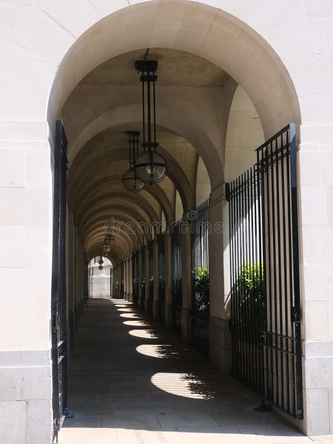 Dramatic View of an Arched Walkway Gated To the Right with Hanging ...