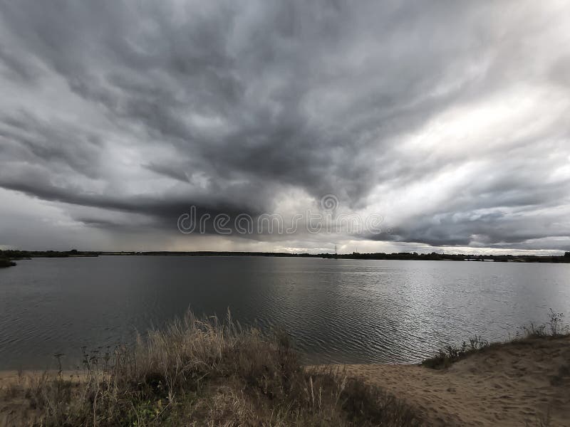 A Dramatic View of the Lake Above Which a Dark Cloud Has Formed Stock ...