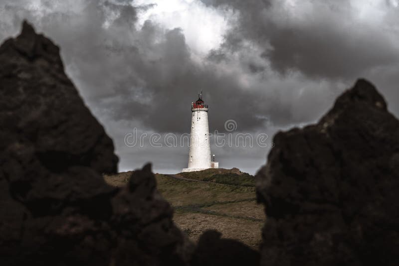 Dramatic View of a Lighthouse Standing Against the Dark Stack of Clouds ...