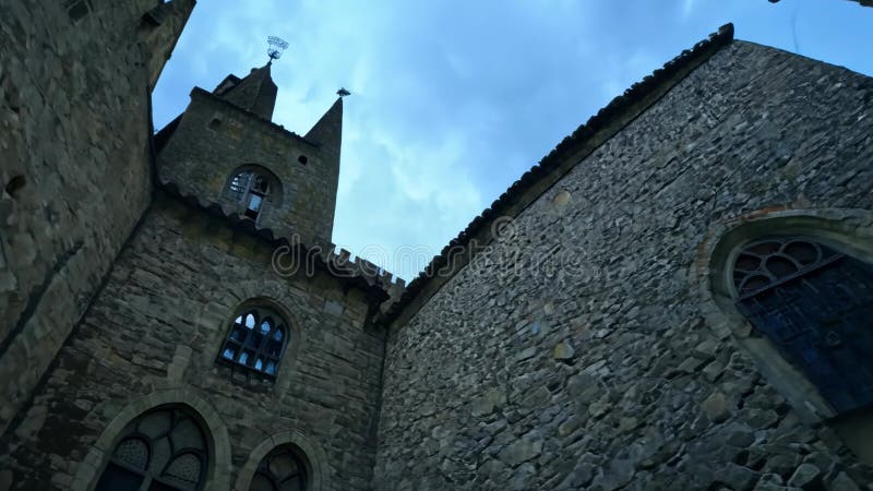 A Dramatic View of an Old Stone Building and a Towering Spire, Set ...