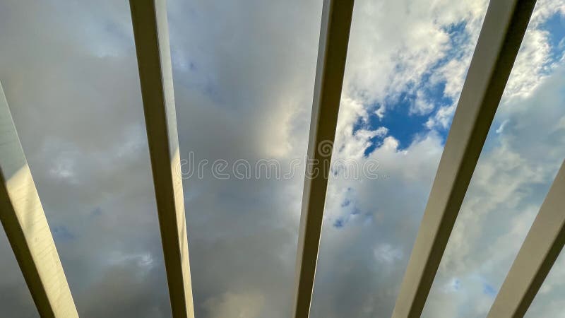 Dramatic View of the Sky with Clouds Framed by Structural Beams ...