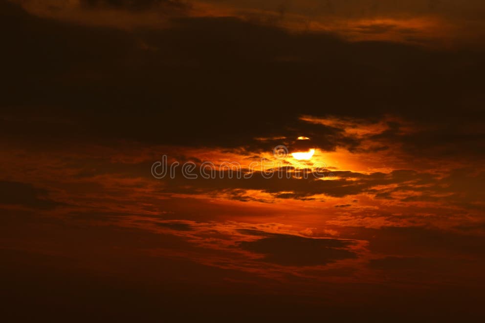 Dramatic View of Sun Hiding in Sky Stock Photo - Image of colorful ...