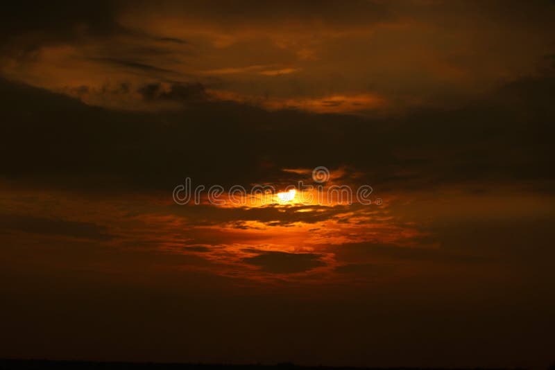 Dramatic View of Sun Hiding in Sky Stock Image - Image of landscape ...