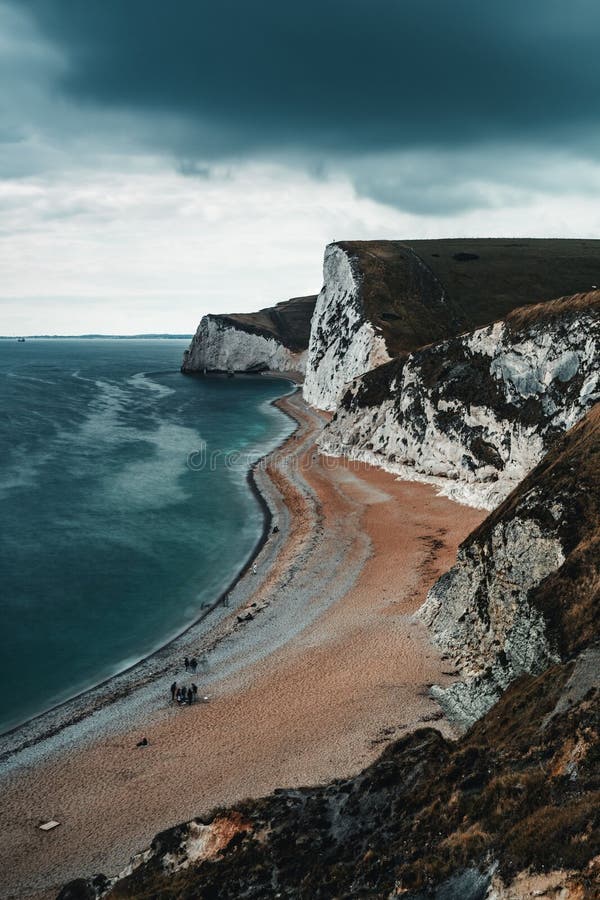 Dramatic View of White Chalk Cliffs Against a Moody Sky at the Jurassic ...