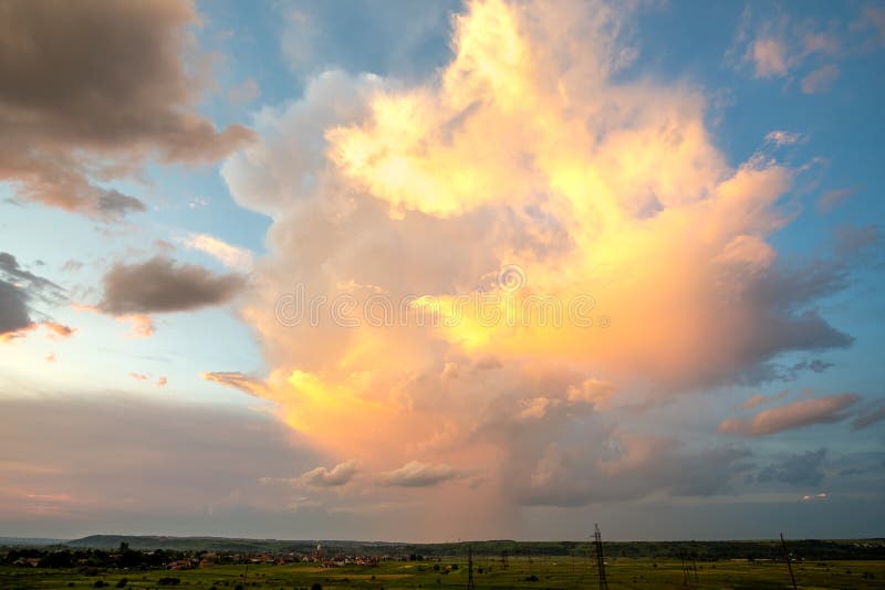 Dramatic Yellow Sunset Over Rural Area with Stormy Puffy Clouds Lit by ...