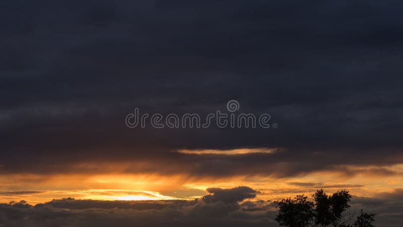 Dramatic Yellow Sunset with Vibrant Clouds Lit by a Sun Stock Image ...