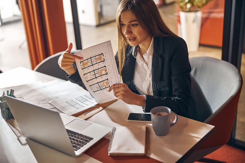 Drasftswoman with a Technical Drawing Communicating Via Skype Stock ...