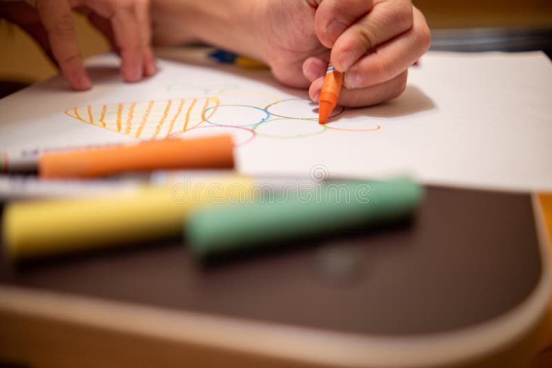 Draw with Colored Pencils on a White Sheet of Paper. Stock Photo ...