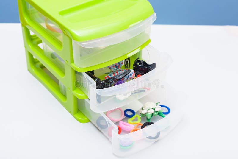 In the Drawer of a Plastic Container are Multi-colored Elastic Bands ...