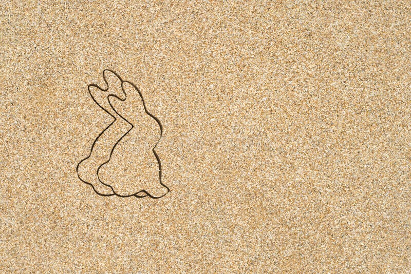 Drawing Creative Two Easter Bunny on the Sand on the Beach. Stock Image ...