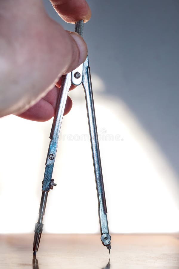 Drawing dividers in hand stock photo. Image of geometric - 67518060