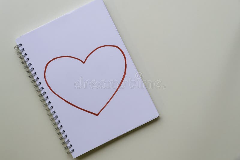 Drawing Heart. with Red Felt-tip Pen on a White Sheet in a Notebook ...