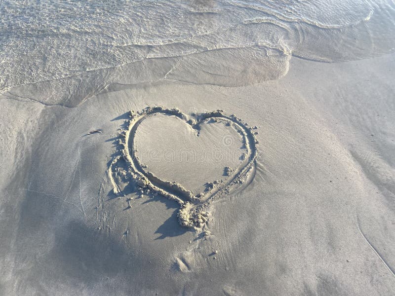Drawing a Heart in the Sand. a Heart is Drawn on the Beach Stock Image ...