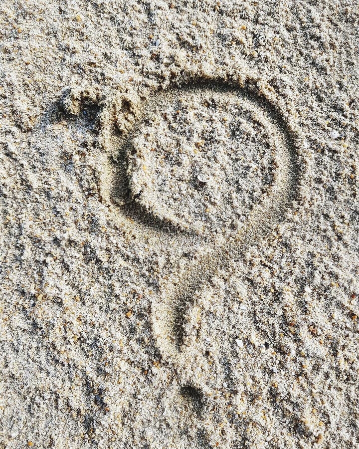 Drawing on sand at beach stock image. Image of abstract - 157583793