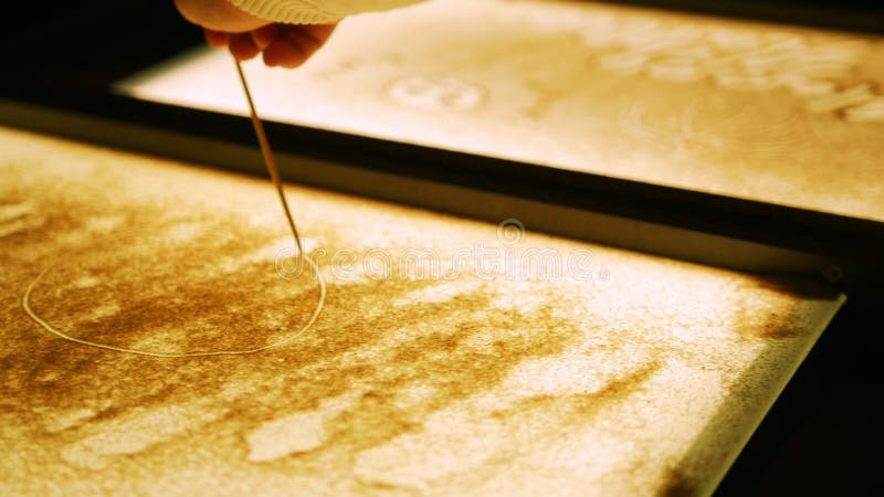 Drawing with a Sand on the Screen. Drawing with a Thin Stick Stock ...