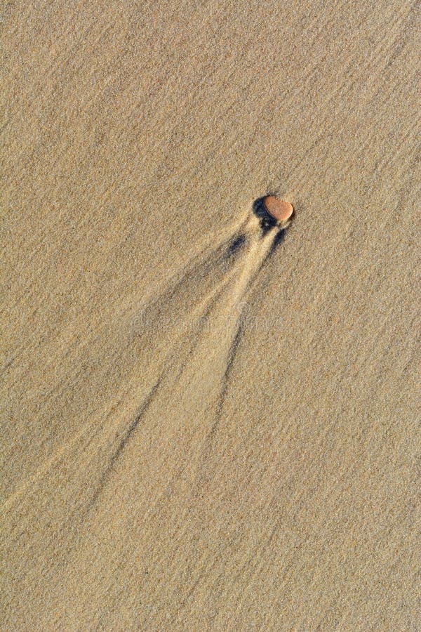 Drawing on the Sand from the Waves. Stone in the Sand. Traces of the ...