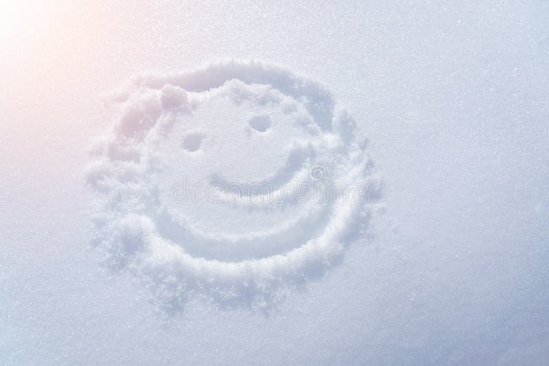 Drawing of a Smiley in the Snow, a Ray of Light. Top View Stock Photo ...