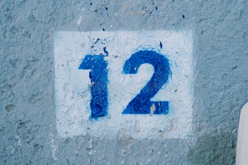 Drawn Number Twelve in a White Rectangle on a Blue Peeling Wall Stock ...