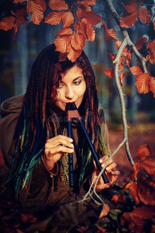 Dreadlocks Woman in Forest, with Double Flute. Stock Photo - Image of ...