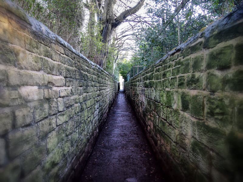 Dreamlike View of a Long Narrow Passageway Surrounded by Stone Walls ...