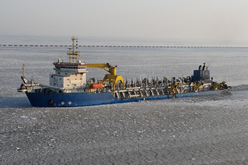 Dredger ship in icy harbor stock image. Image of vessel - 13190133
