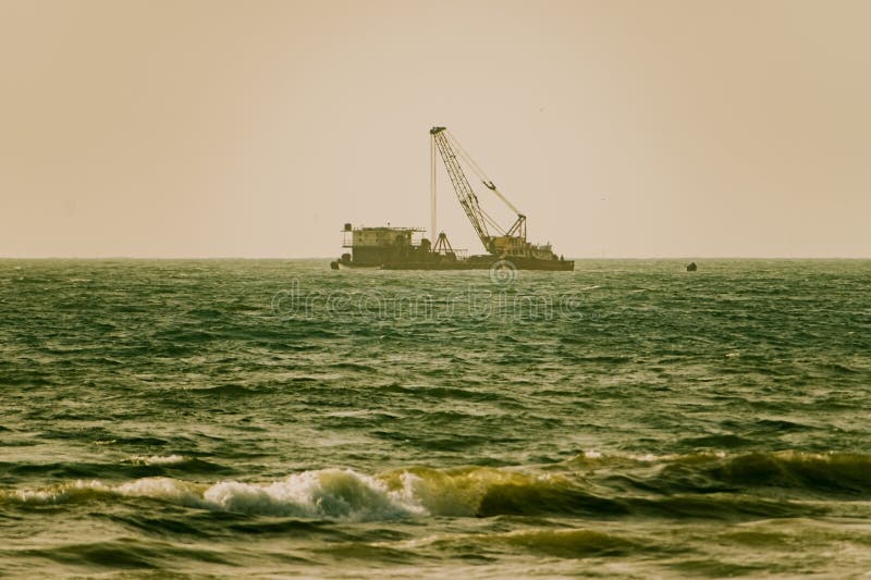 Dredger Working at Sea. Ship Excavating Material from a Water ...