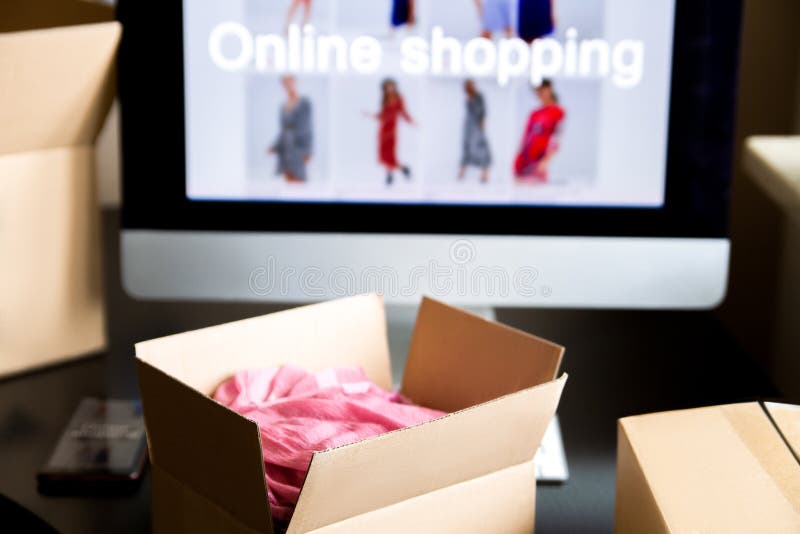 The Dress is Hanging on the Computer. Boxes with Clothes, Keyboard ...