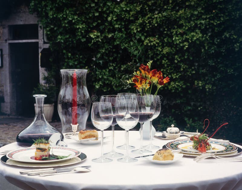Dressed Gourmet Table Against Outdoor Luxurious Foliage Stock Image ...