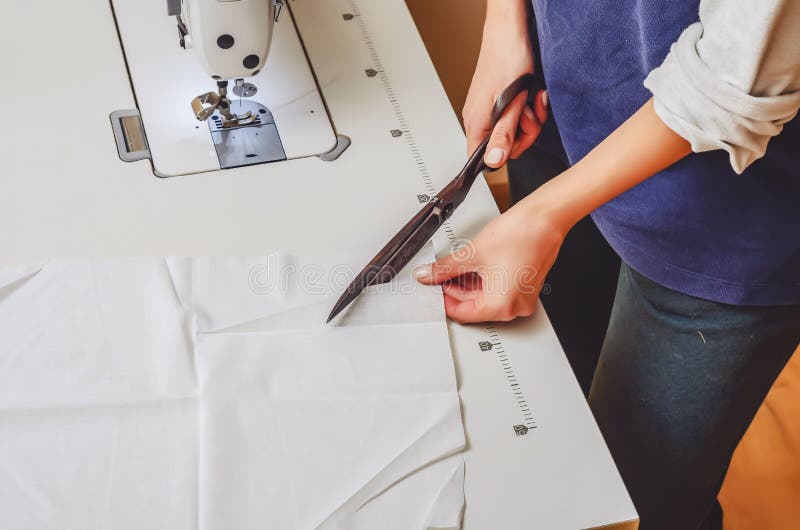 The Dressmaker Cuts the White Cloth on Table Stock Photo - Image of ...