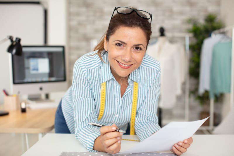 Dressmaker in Studio Holding Sheet Paper Stock Photo - Image of ...