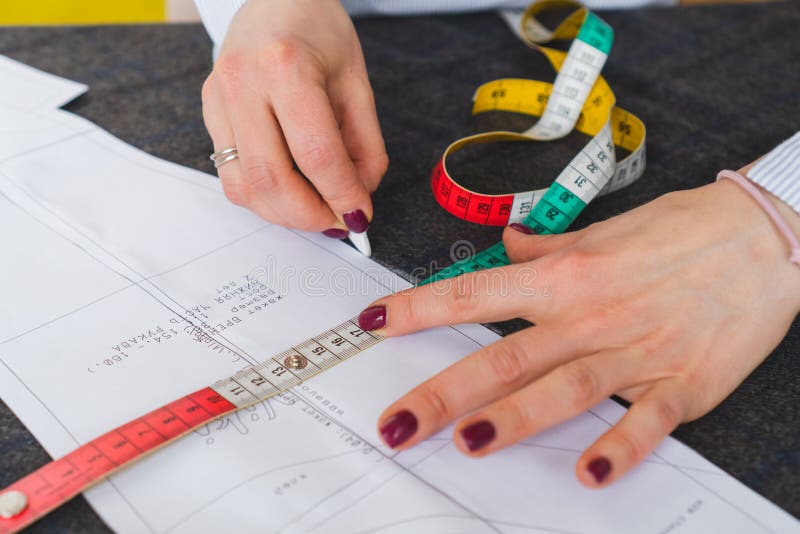 Dressmaker Marks Piece of Fabric with Chalk According To Paper Pattern ...