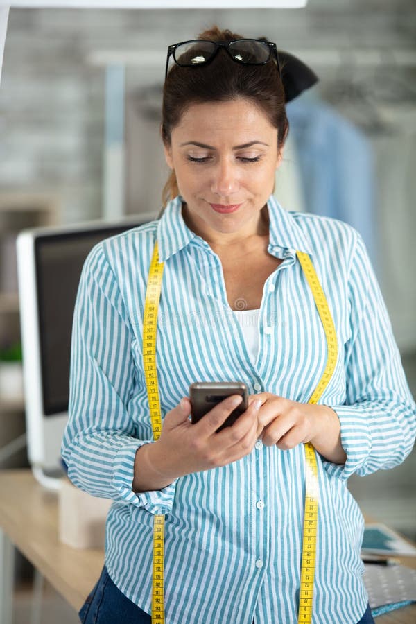 Dressmaker Using Smartphone To Send Message Stock Photo - Image of ...